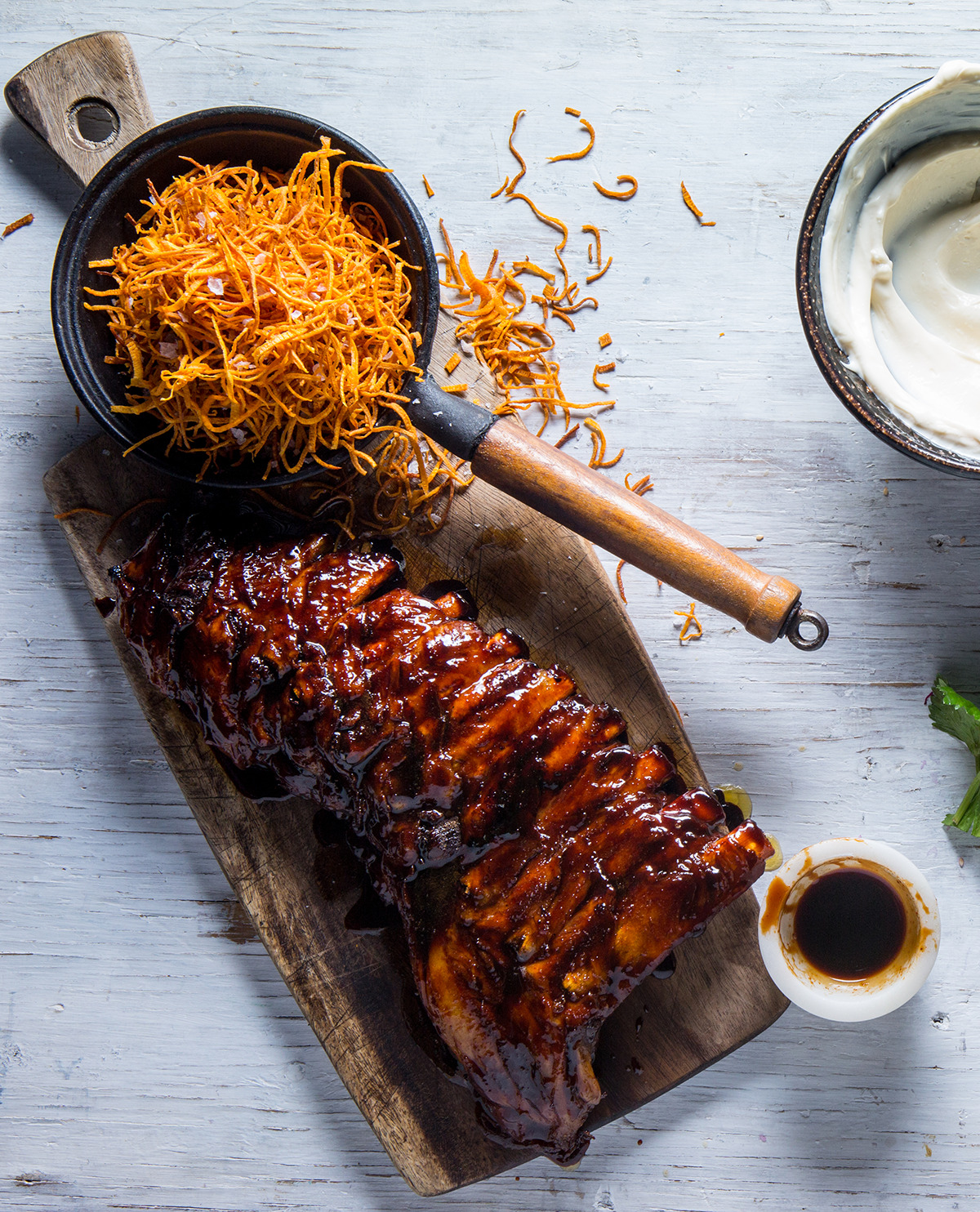 Supersized tender pork ribs with sweet potato fries | Woolworths TASTE