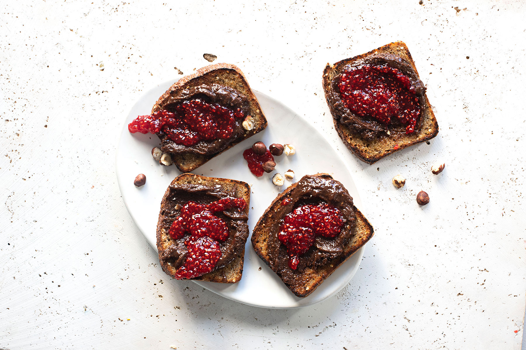 Home-made chocolate hazelnut spread and raspberry jam on toast ...