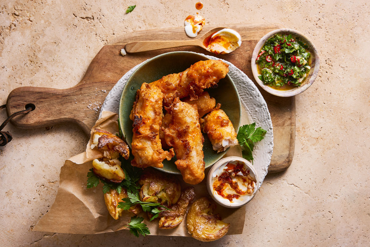 Harissa-battered hake with spring onion chimichurri recipe